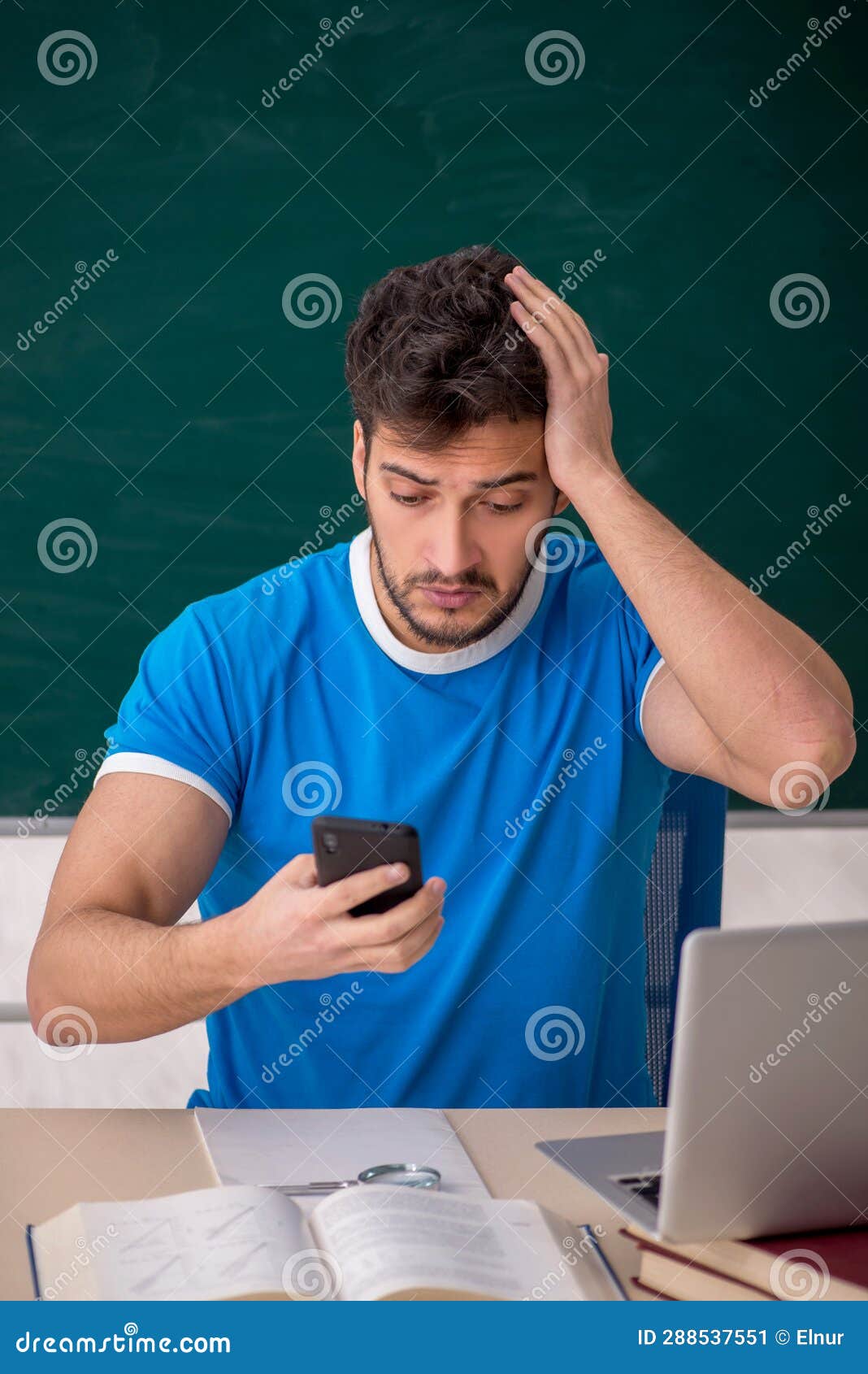 Young Male Student Holding Smartphone in the Classroom Stock Image ...