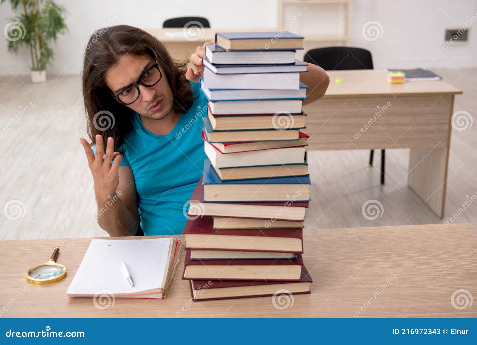 Young Male Student and a Lot of Books in the Class Stock Image - Image ...