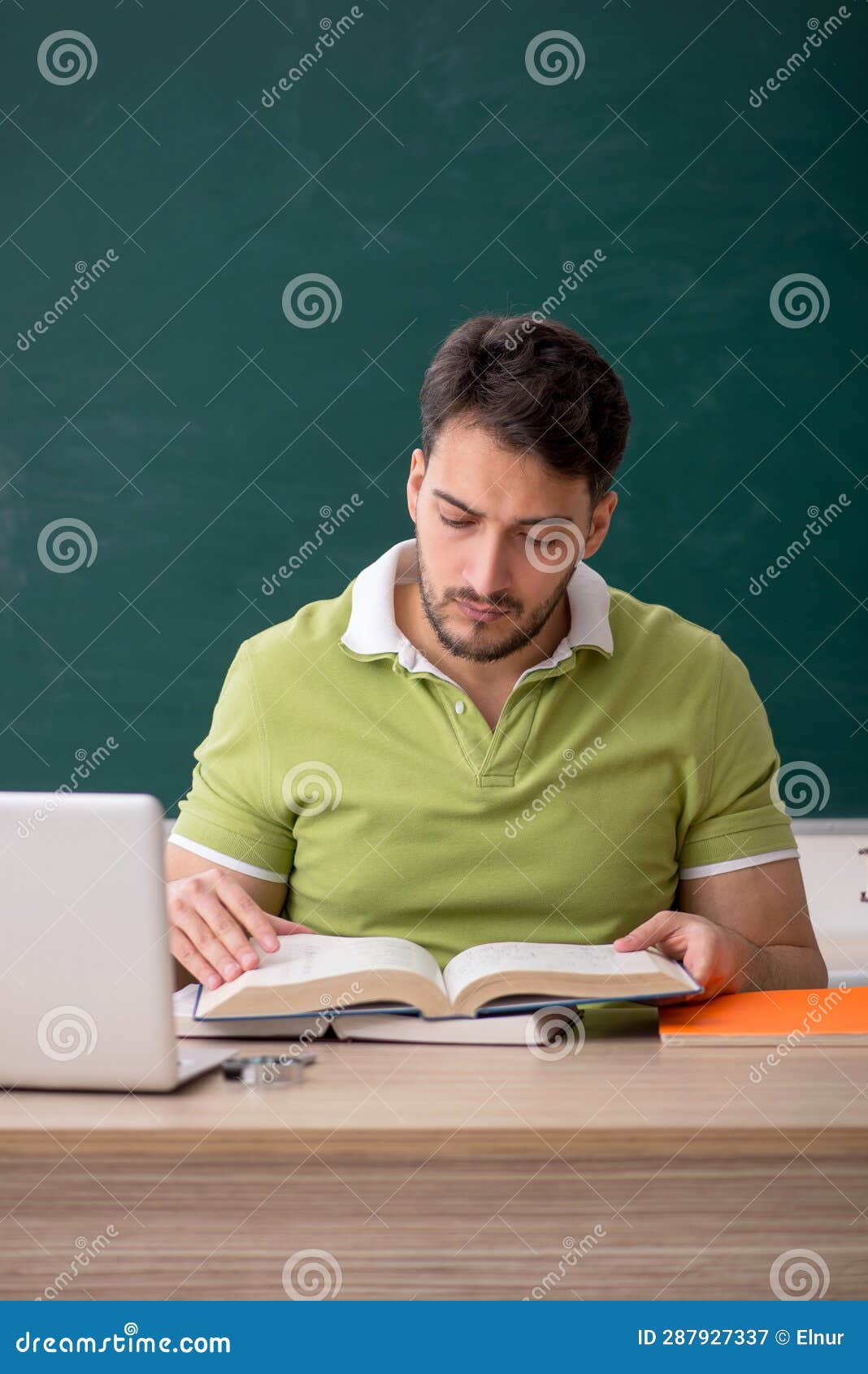 Young Male Student Sitting in Front of Green Board Stock Image - Image ...