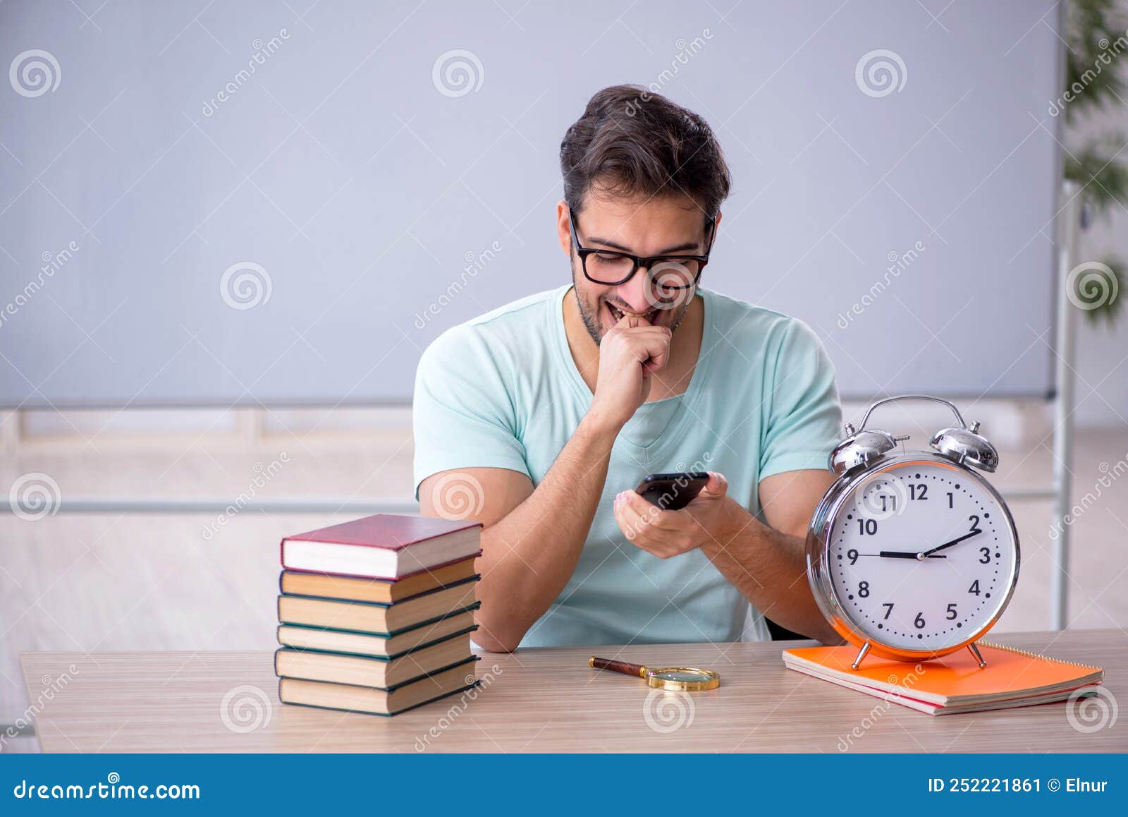 Young Male Student in Time Management Concept in the Classroom Stock ...