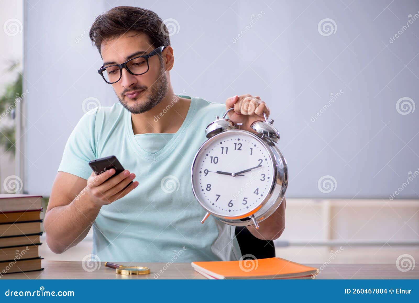 Young Male Student in Time Management Concept in the Classroom Stock ...