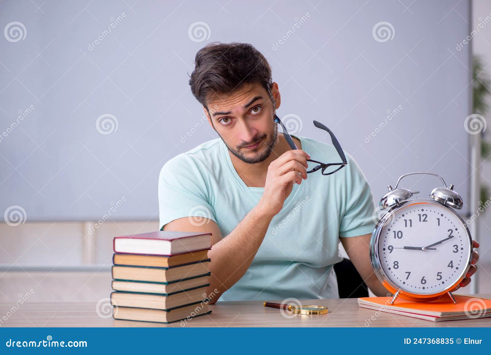 Young Male Student in Time Management Concept in the Classroom Stock ... Young Male Student in Time Management Concept in the Classroom Stock ...