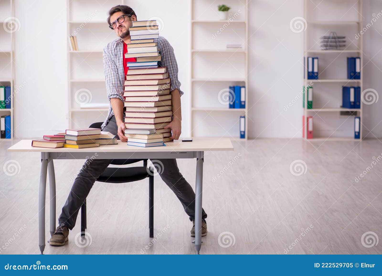 Young Male Student and Too Many Books in the Classroom Stock Image ...