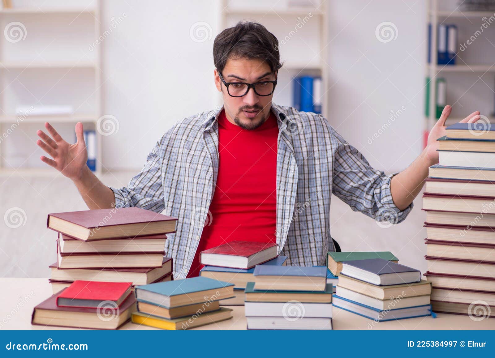 Young Male Student and Too Many Books in the Classroom Stock Image ...