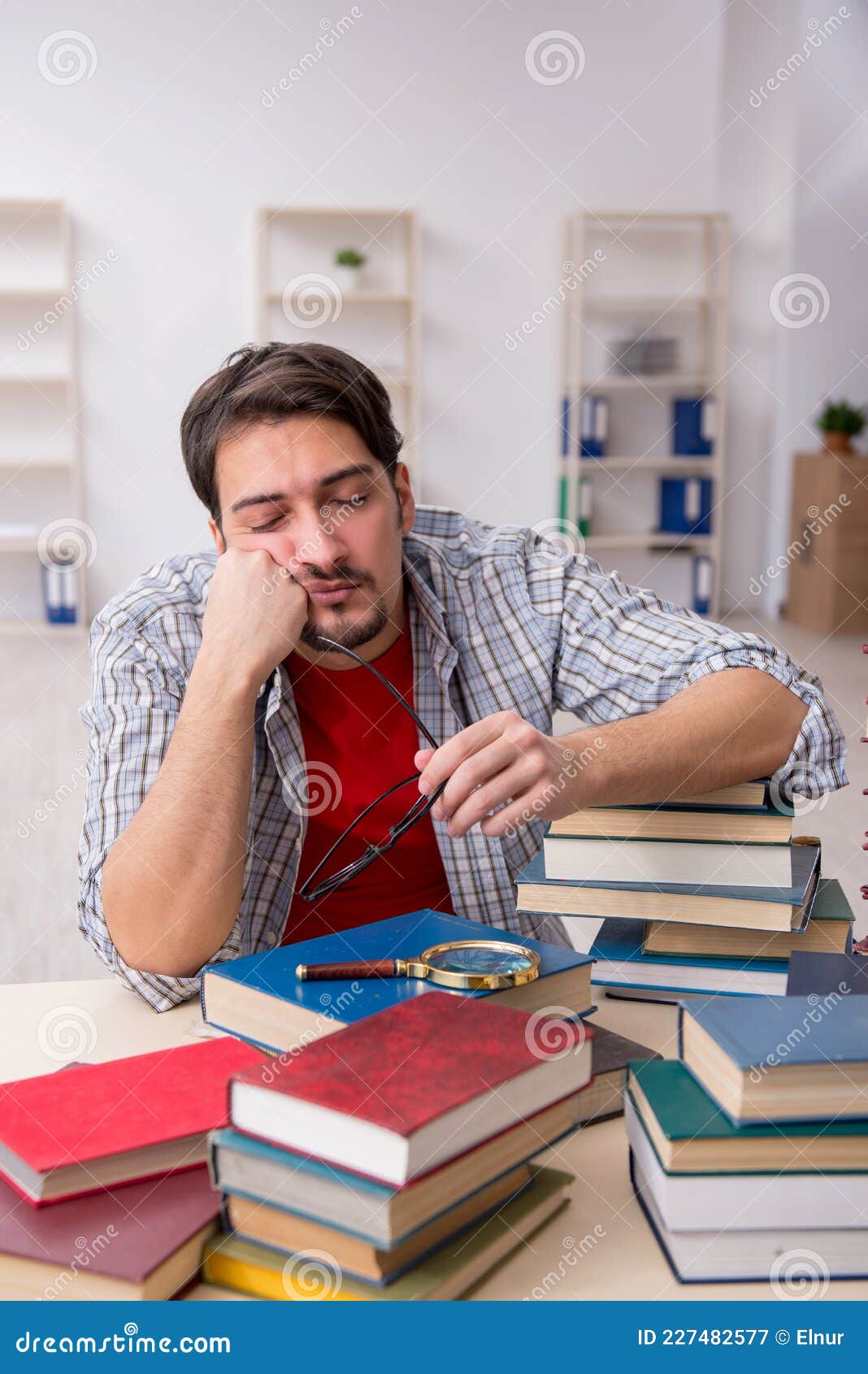 Young Male Student and Too Many Books in the Classroom Stock Image ...
