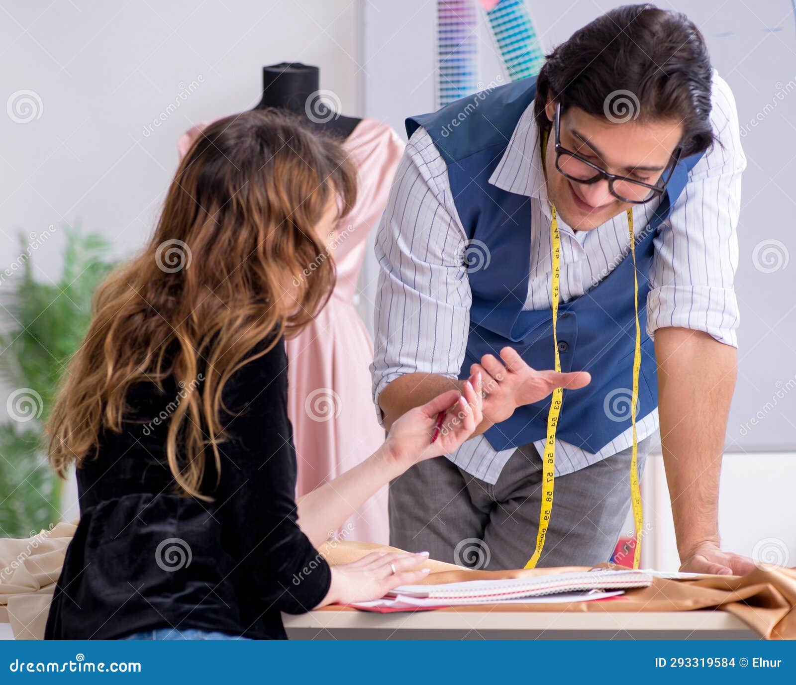 Young Male Tailor Teaching Female Student Stock Photo - Image of ...