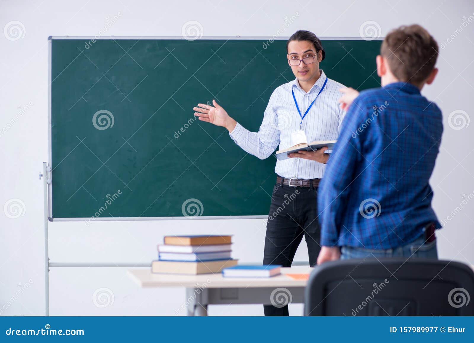 Young Male Teacher and Boy in the Classroom Stock Image - Image of ...