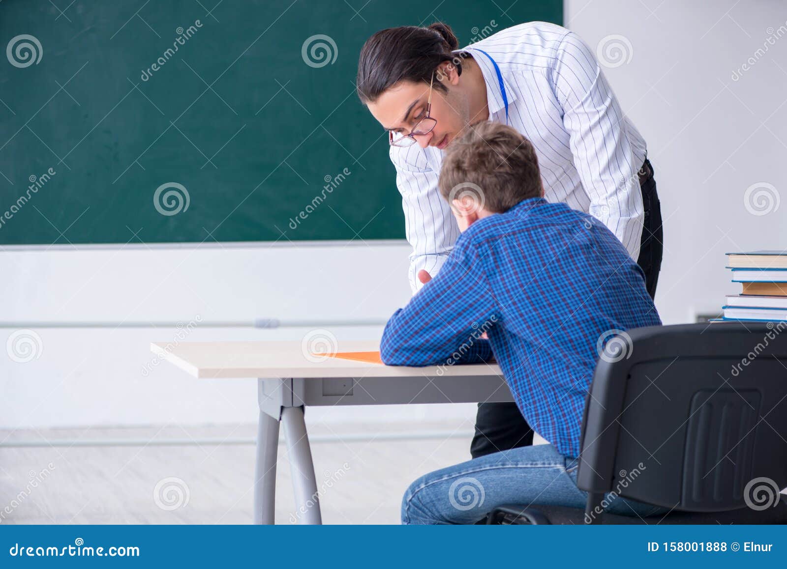 Young Male Teacher and Boy in the Classroom Stock Photo - Image of exam ...
