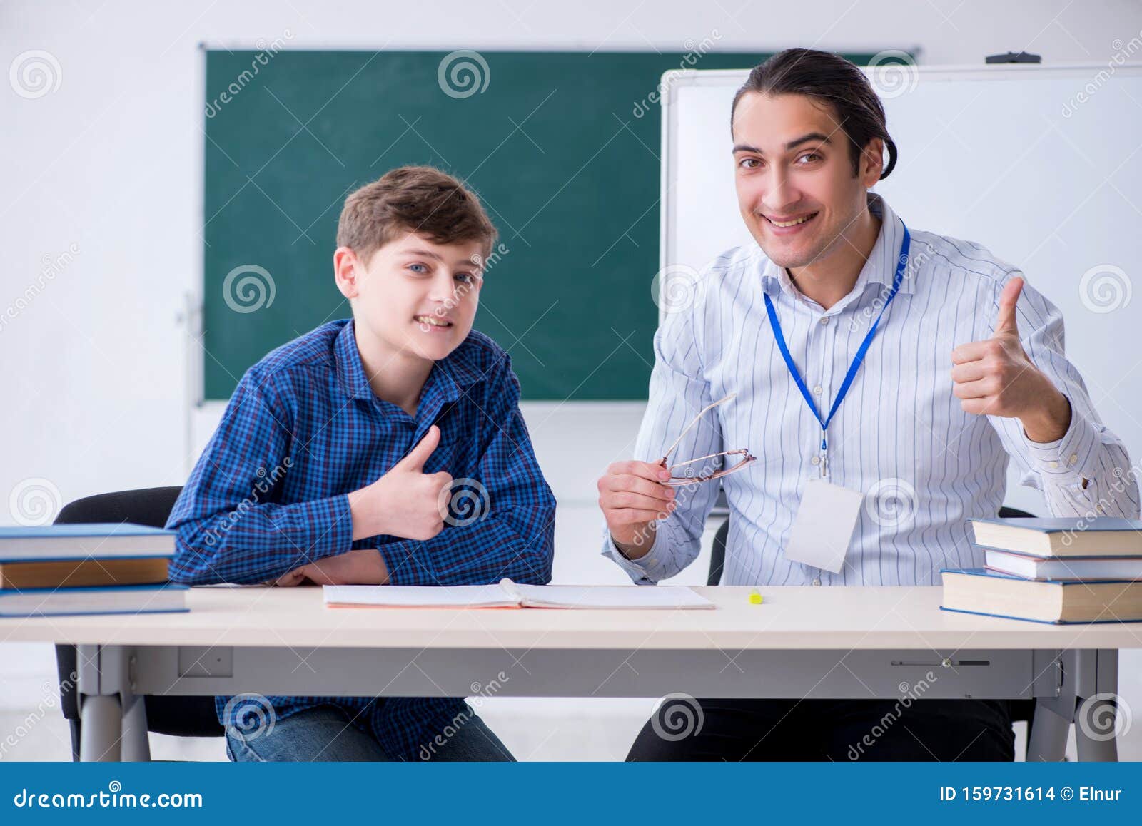 Young Male Teacher and Boy in the Classroom Stock Photo - Image of ...