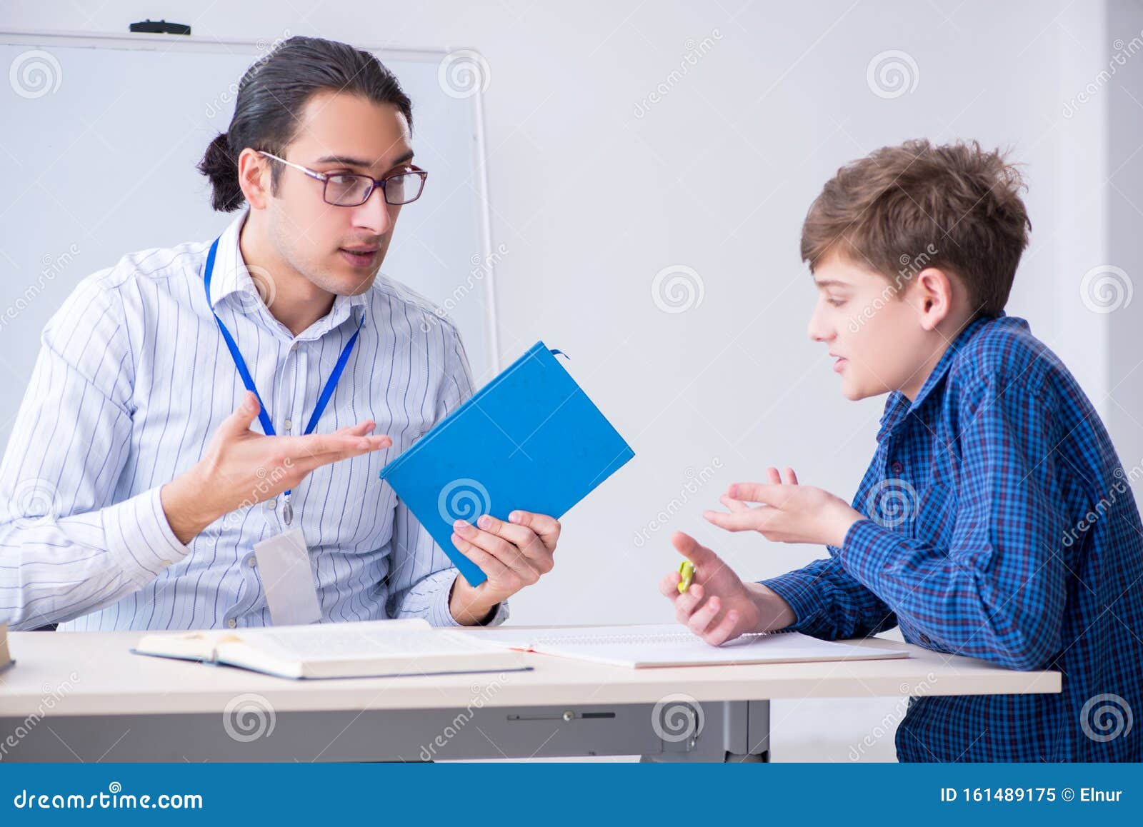 Young Male Teacher and Boy in the Classroom Stock Image - Image of ...