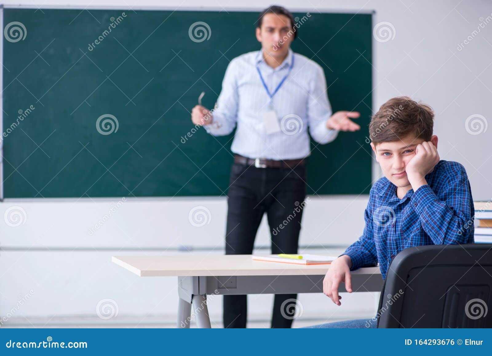 Young Male Teacher and Boy in the Classroom Stock Photo - Image of ...