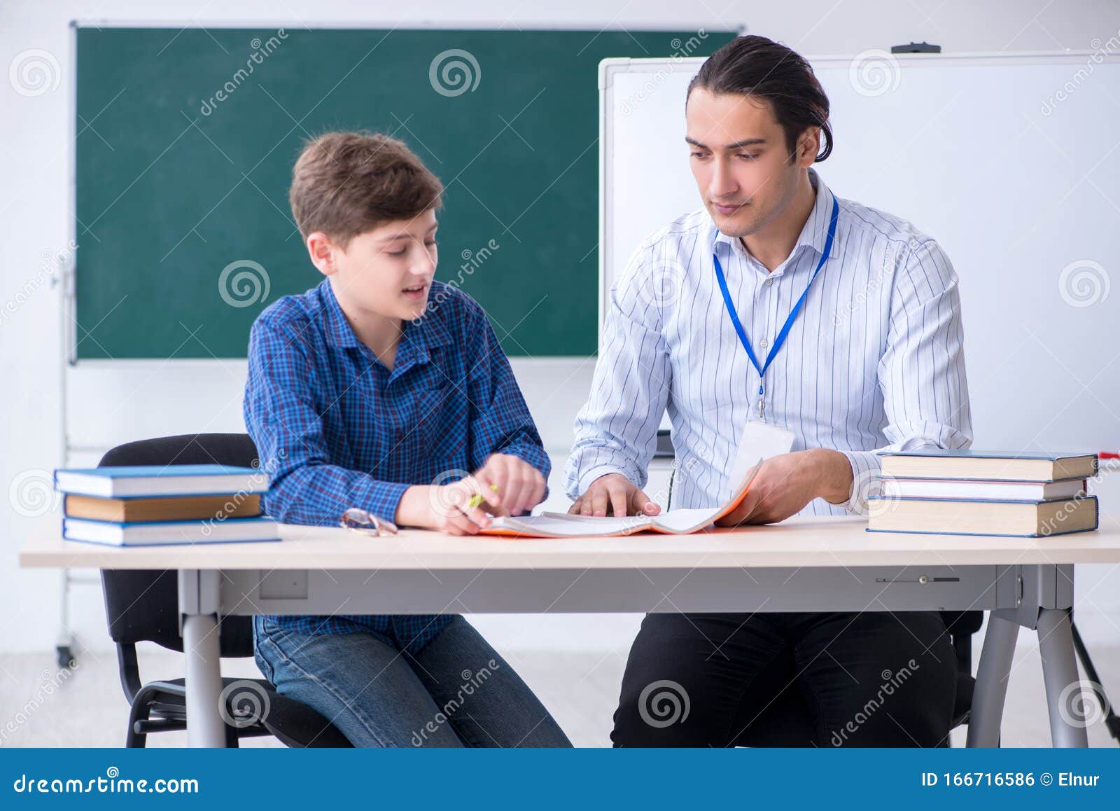 Young Male Teacher and Boy in the Classroom Stock Photo - Image of ...