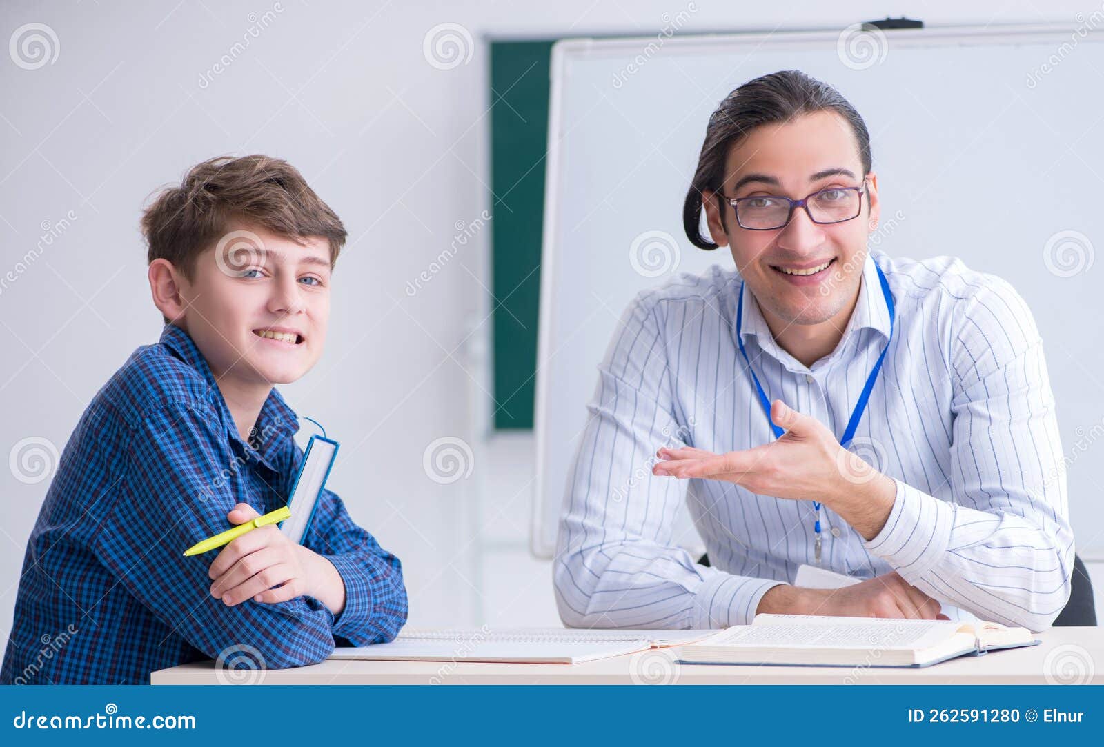 Young Male Teacher and Boy in the Classroom Stock Photo - Image of ...