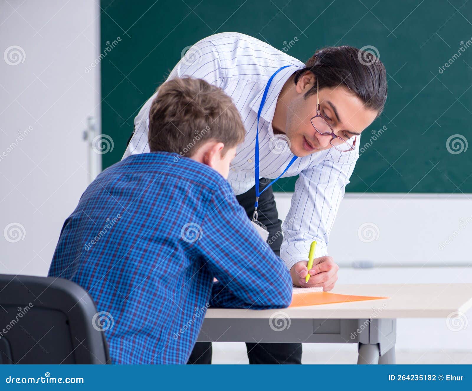 Young Male Teacher and Boy in the Classroom Stock Photo - Image of ...