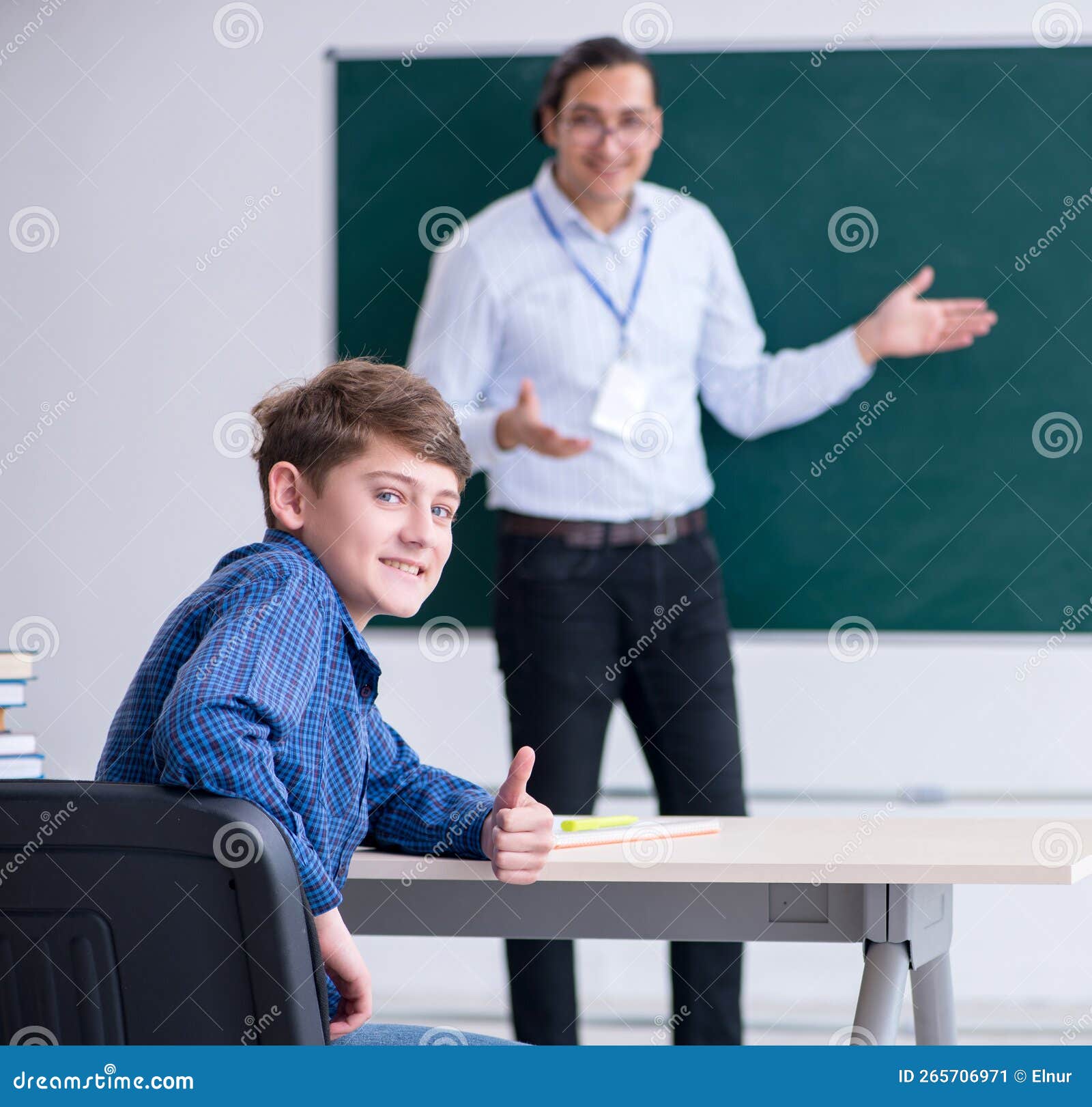 Young Male Teacher and Boy in the Classroom Stock Image - Image of ...