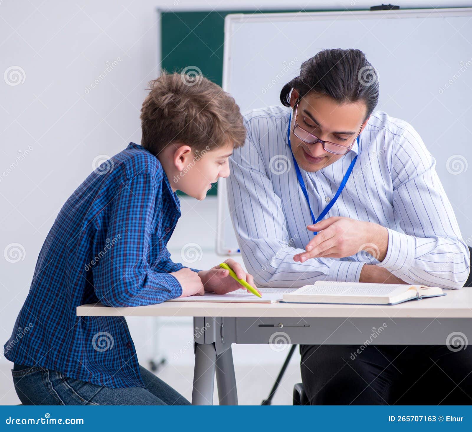 Young Male Teacher and Boy in the Classroom Stock Image - Image of ...