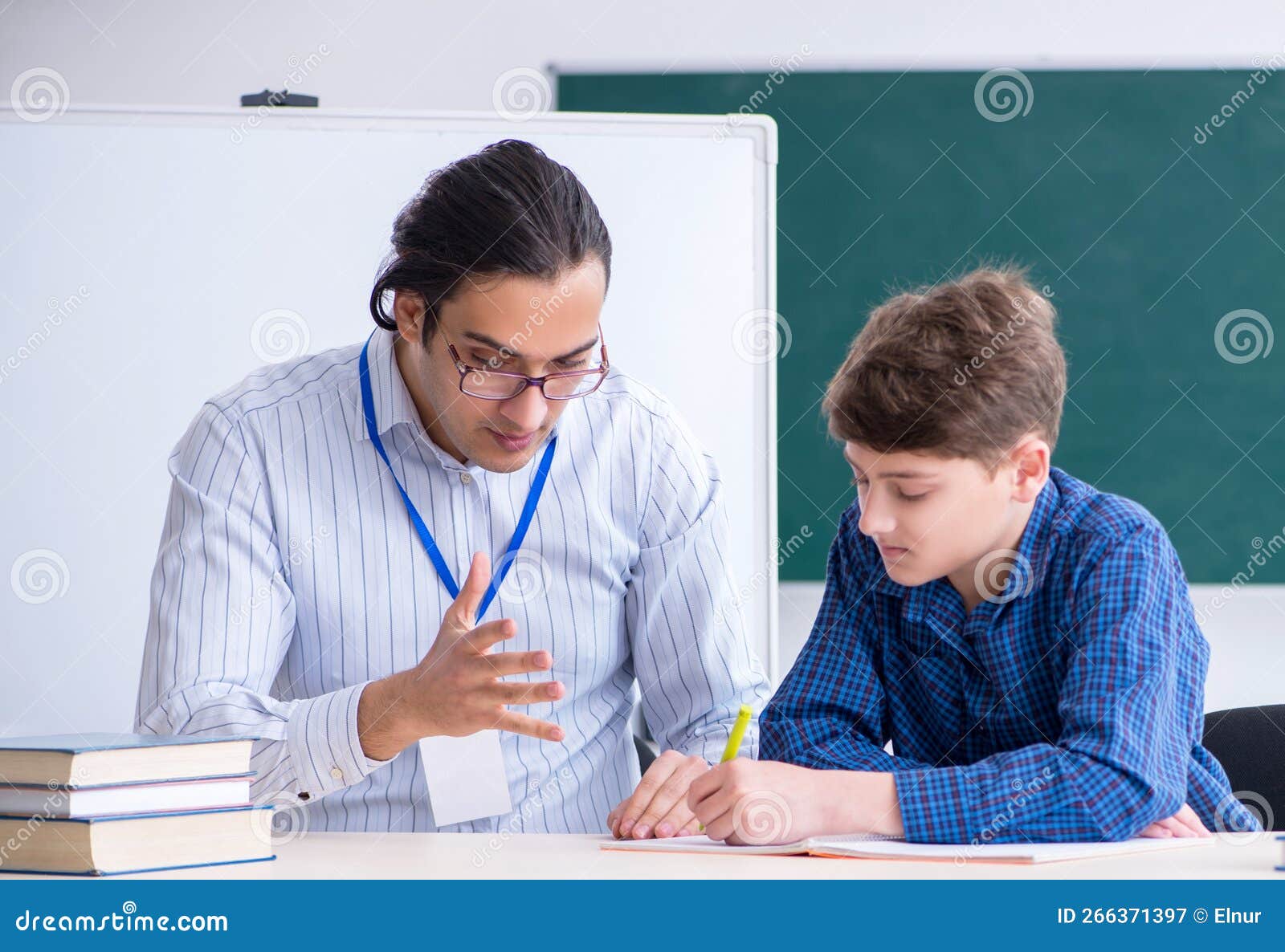 Young Male Teacher and Boy in the Classroom Stock Image - Image of ...