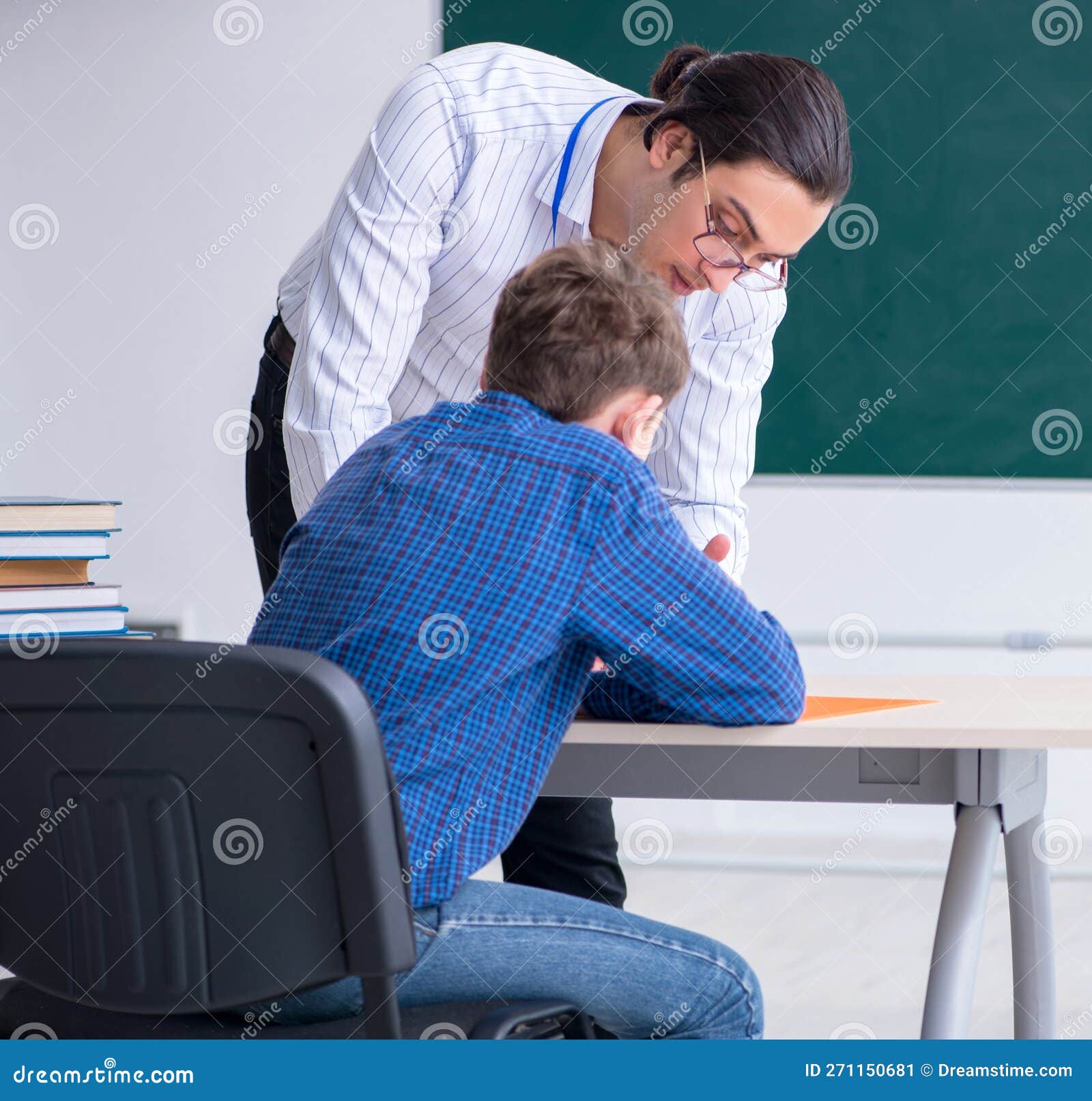 Young Male Teacher and Boy in the Classroom Stock Image - Image of ...