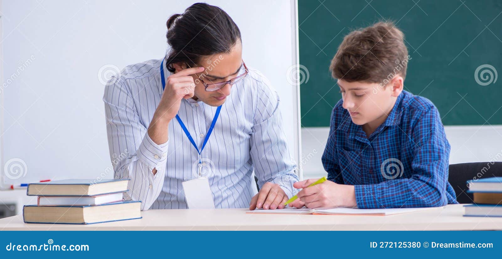 Young Male Teacher and Boy in the Classroom Stock Photo - Image of ...