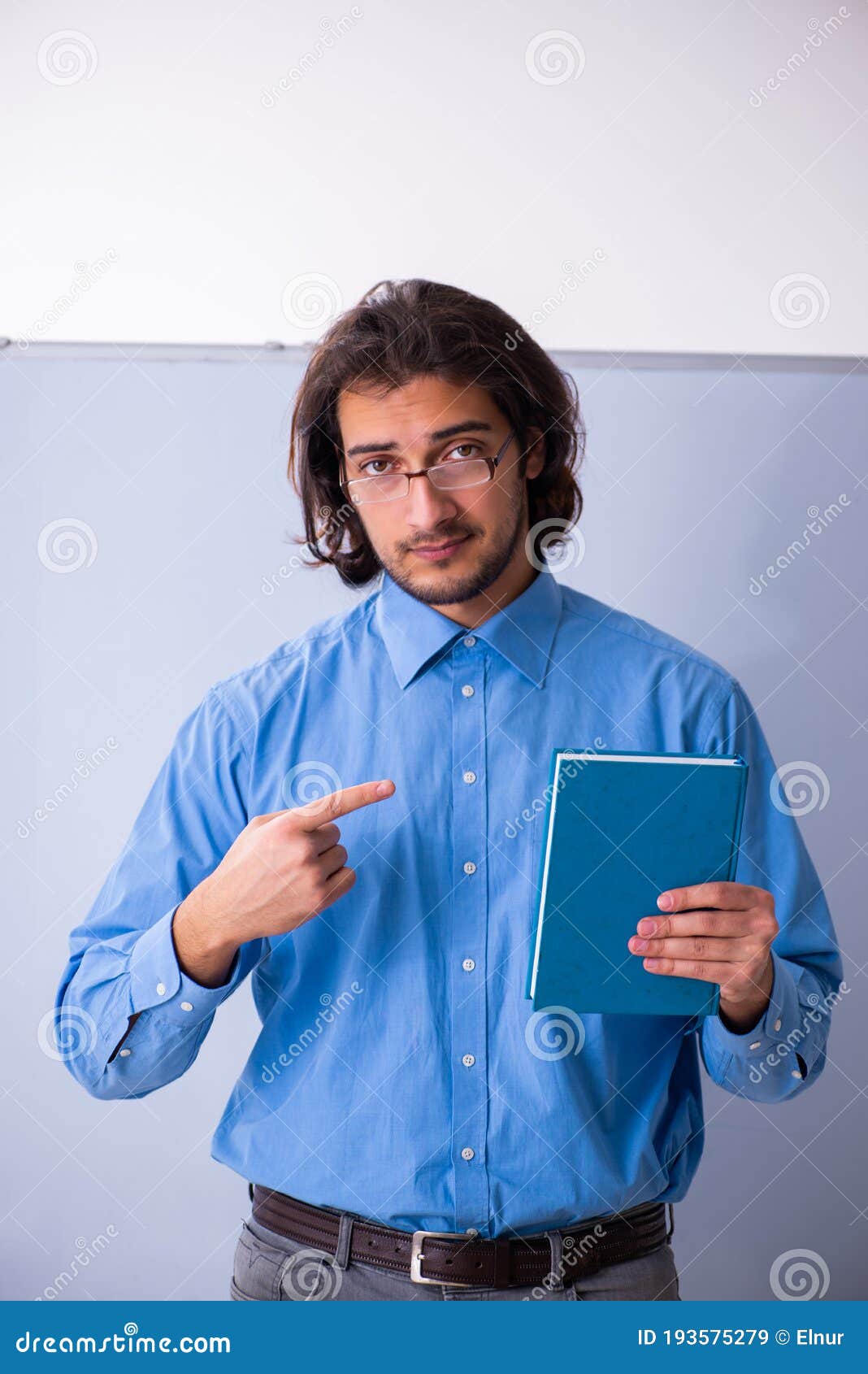 Young Male Teacher in the Classroom Stock Image - Image of reading ...