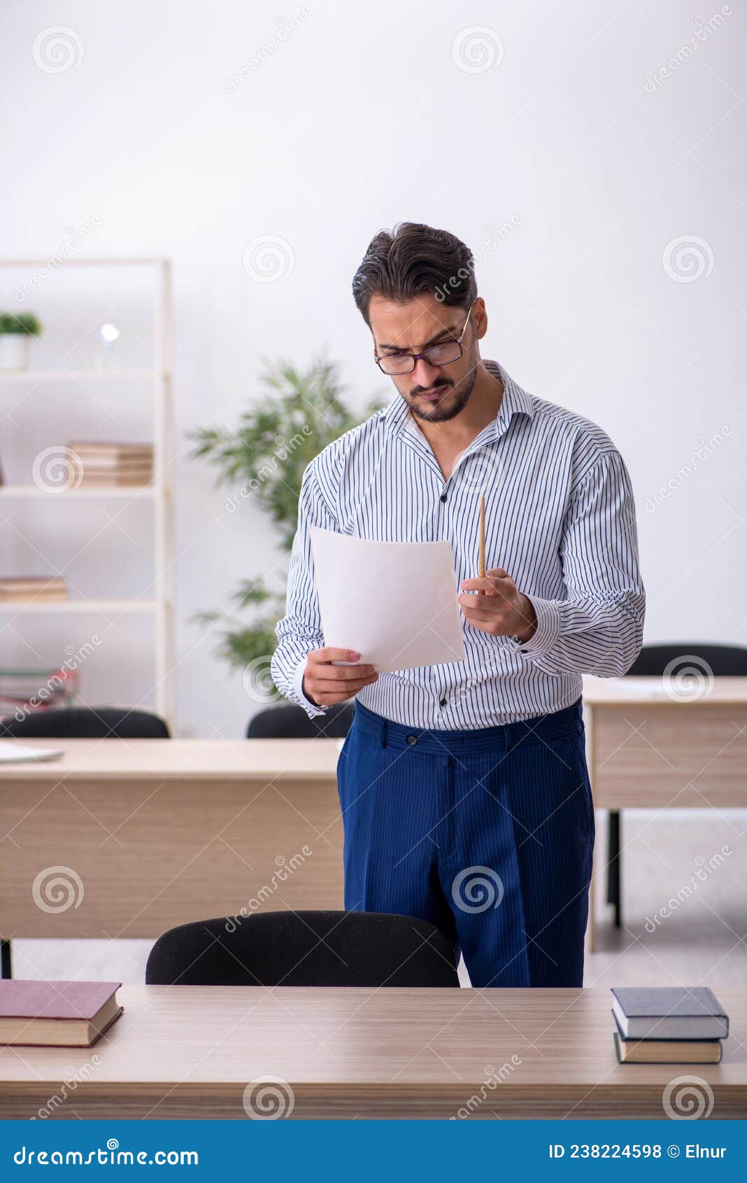 Young Male Teacher in the Classroom Stock Photo - Image of secondary ...