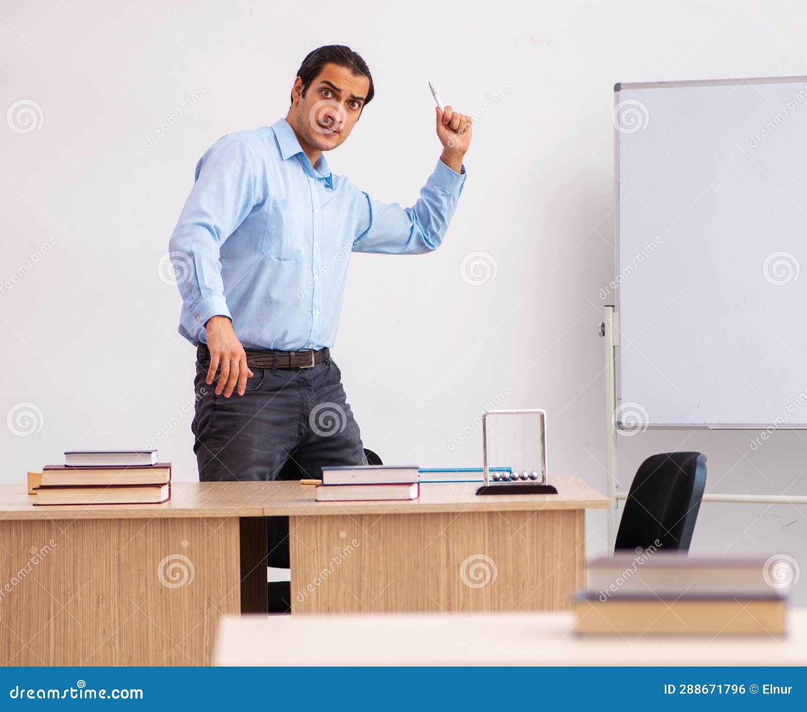 Young Male Teacher in the Classroom Stock Photo - Image of education ...