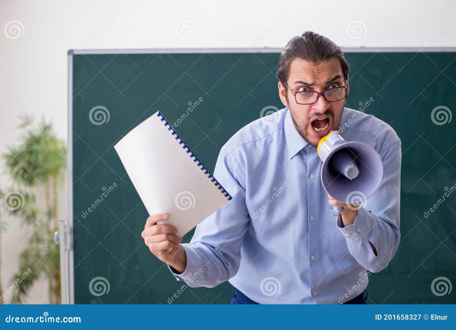 Young Male Teacher in the Classroom Holding Megaphone Stock Image ...