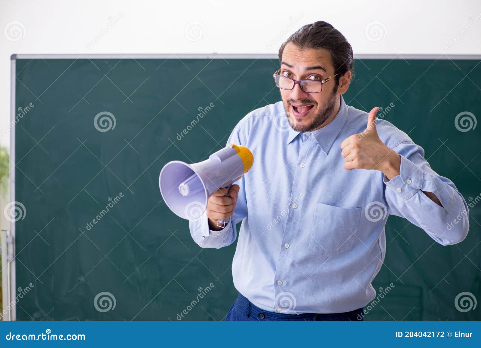 Young Male Teacher in the Classroom Holding Megaphone Stock Photo ...