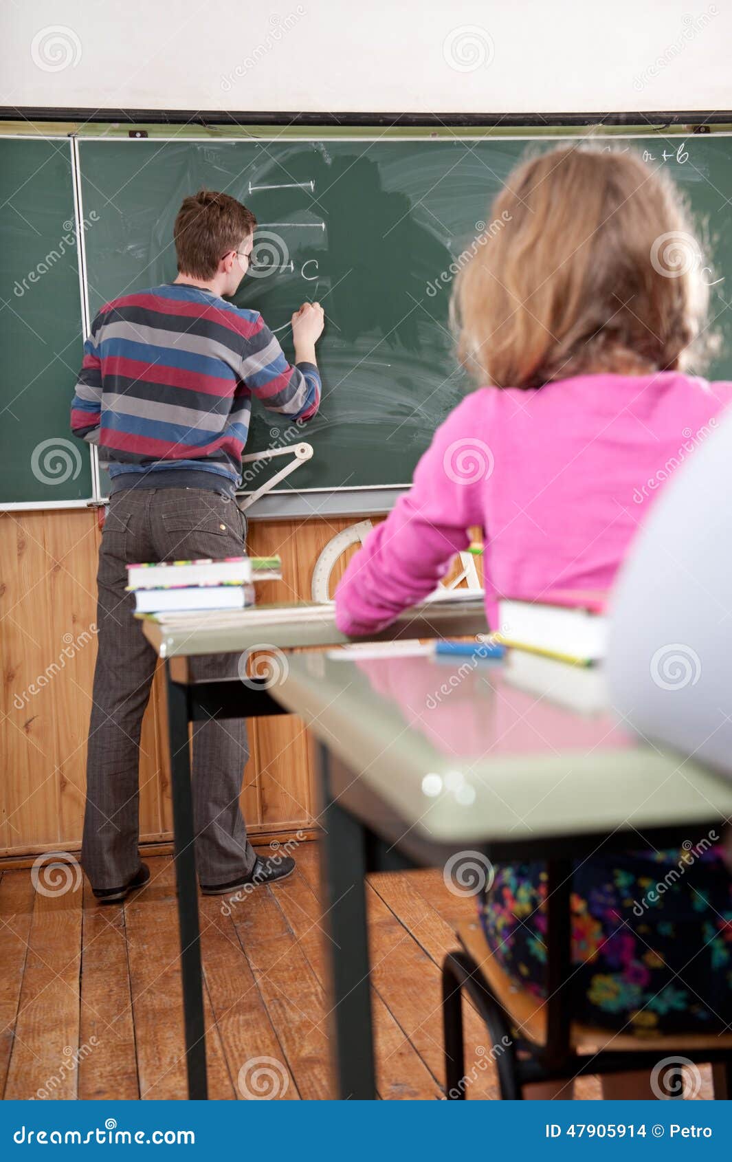 Young Male Teacher Explaining Math at Blackboard Stock Photo - Image of ...