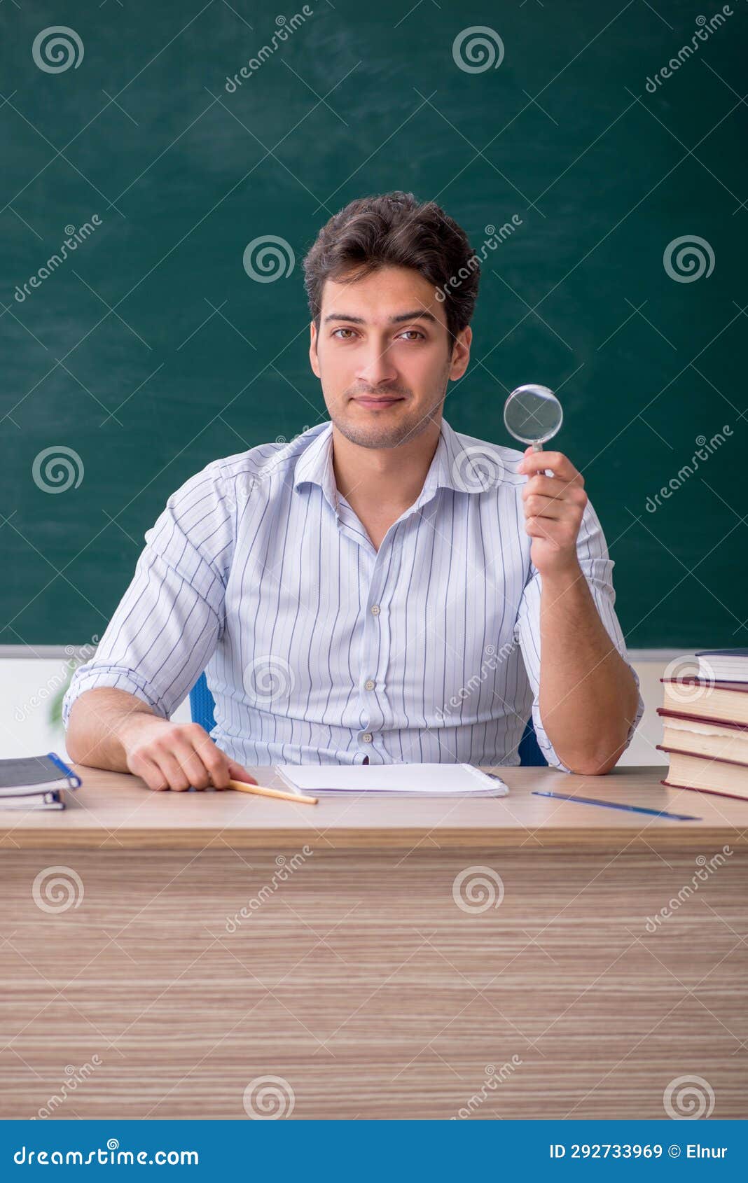 Young Male Teacher in Front of Green Board Stock Image - Image of ...