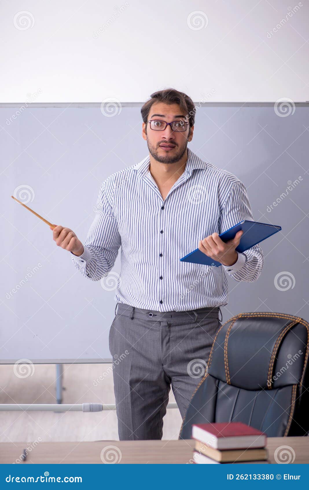 Young Male Teacher Sitting in the Classroom Stock Photo - Image of ...