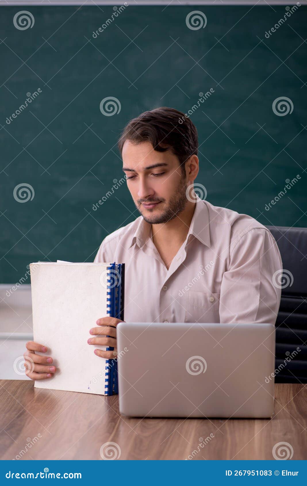 Young Male Teacher Sitting in the Classroom Stock Image - Image of male ...