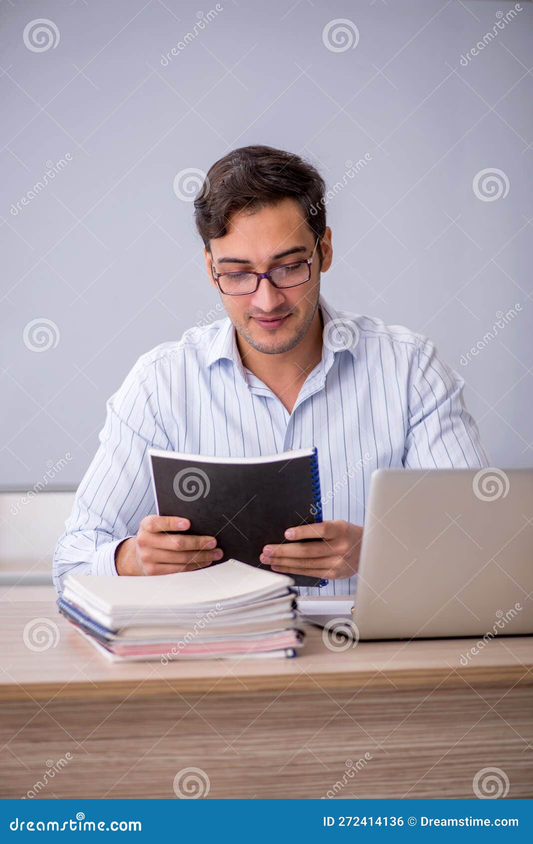 Young Male Teacher Sitting in the Classroom Stock Photo - Image of ...