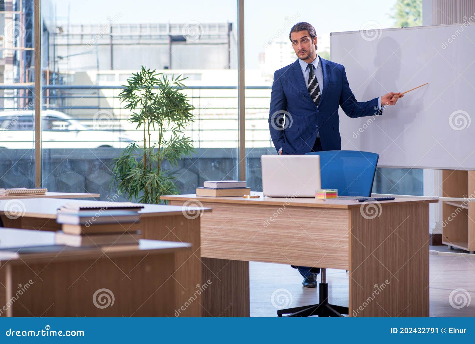 Young Male Teacher in Suit in the Classroom Stock Image - Image of ...