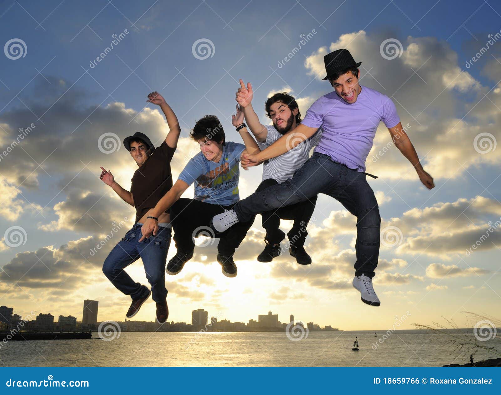 Young Male Team Jumping Outdoors Stock Photo - Image of friends ...