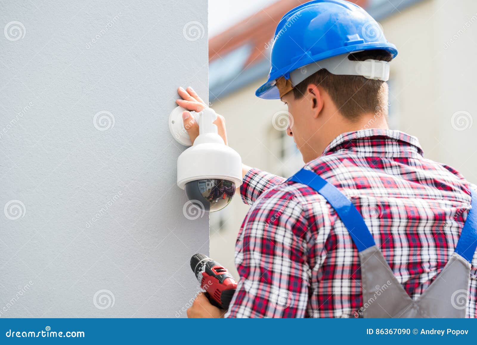 Young Male Technician Installing Camera on Wall Stock Photo - Image of ...