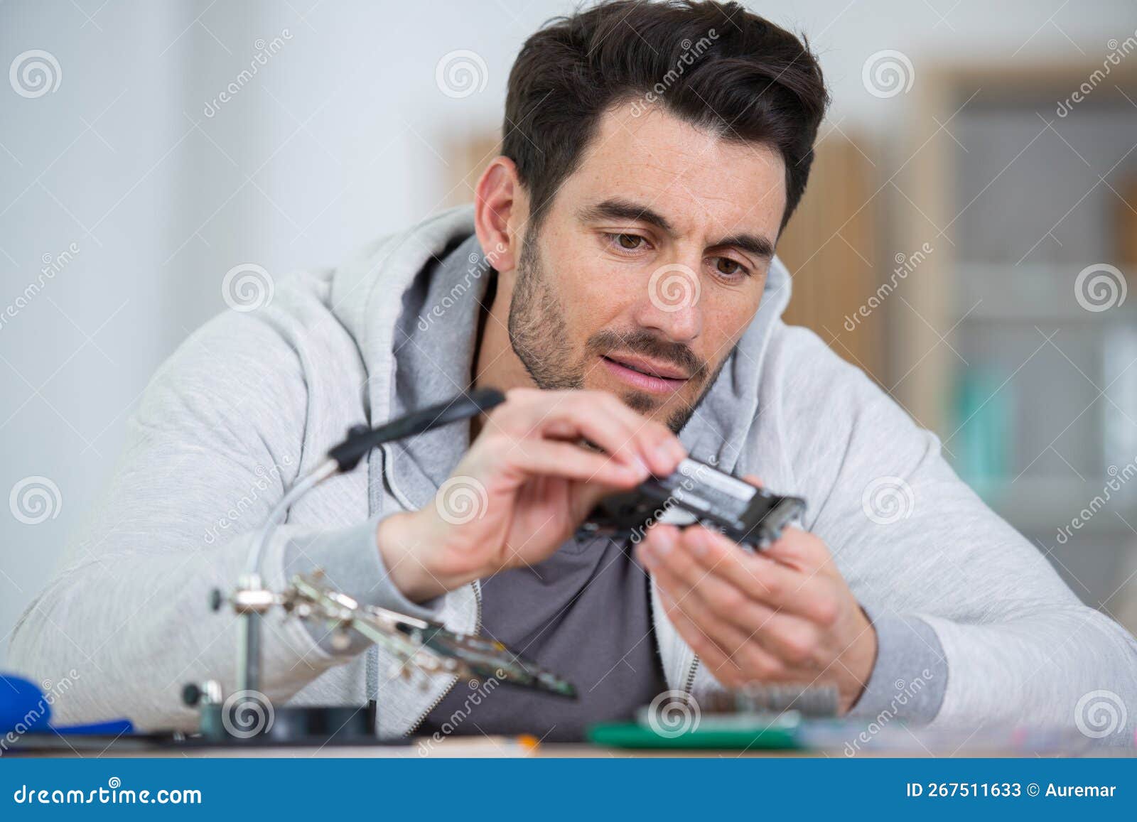 Young Male Technician Repairing Computer Using Magnifying Glass Stock ...