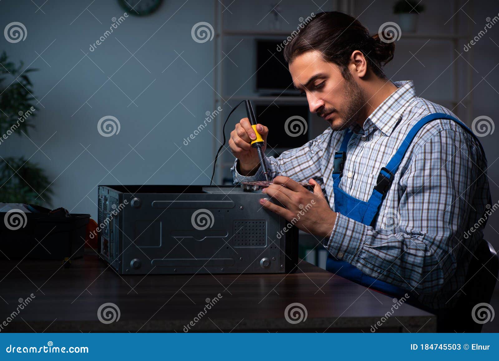 Young Male Technician Repairing Computer in Workshop at Night Stock ...