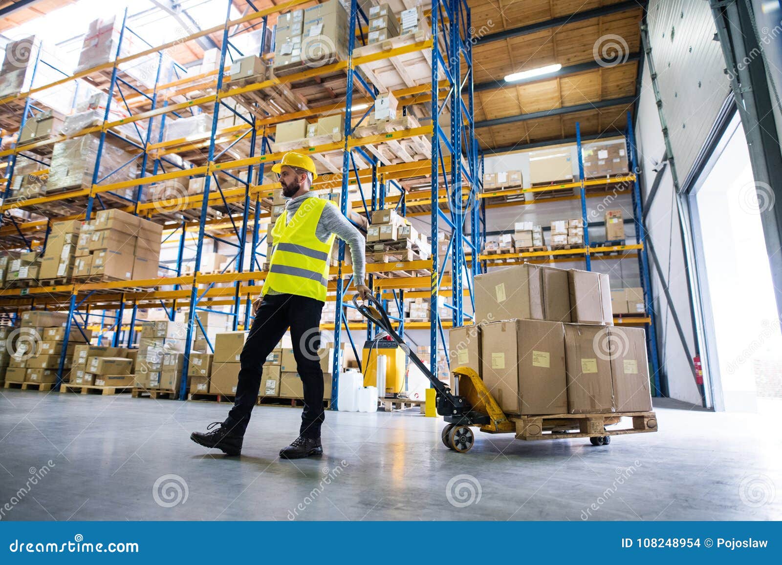 Male Warehouse Worker Pulling A Pallet Truck. Stock Photography ...