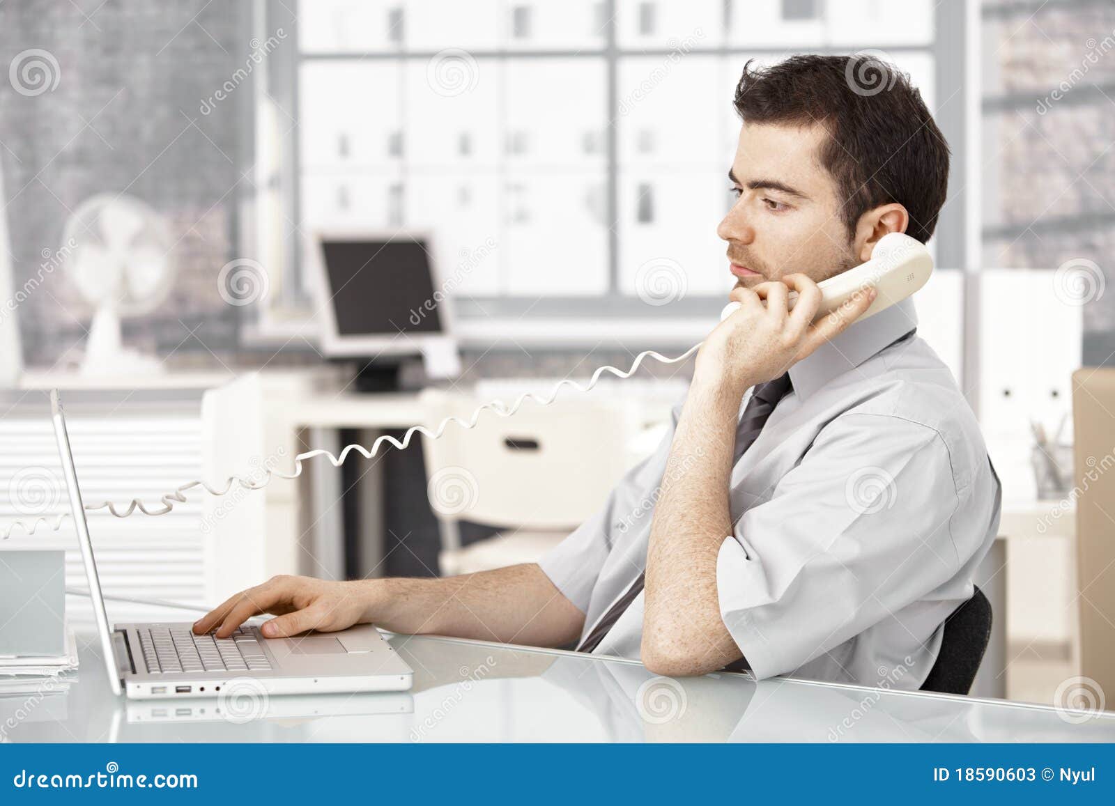 Young Male Working in Office Talking on Phone Stock Image - Image of ...