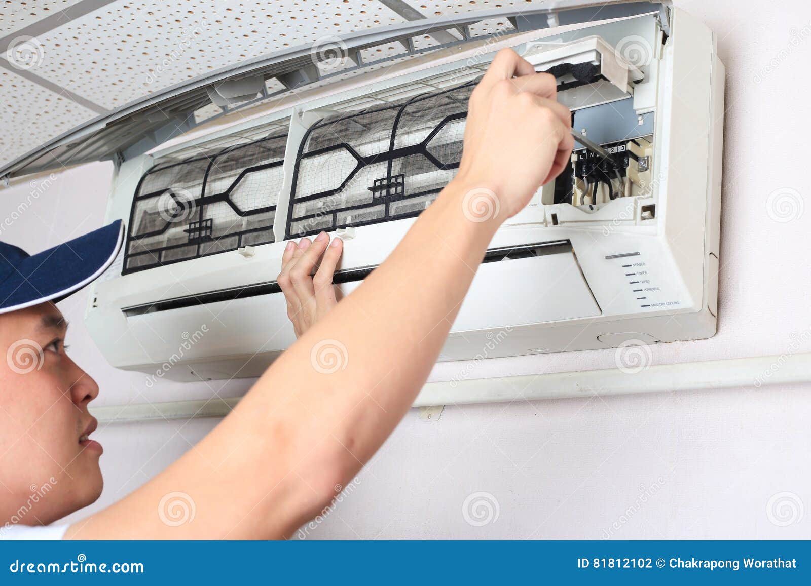 Young Man Adjusting Air Conditioning System in Bedroom. Stock Photo ...