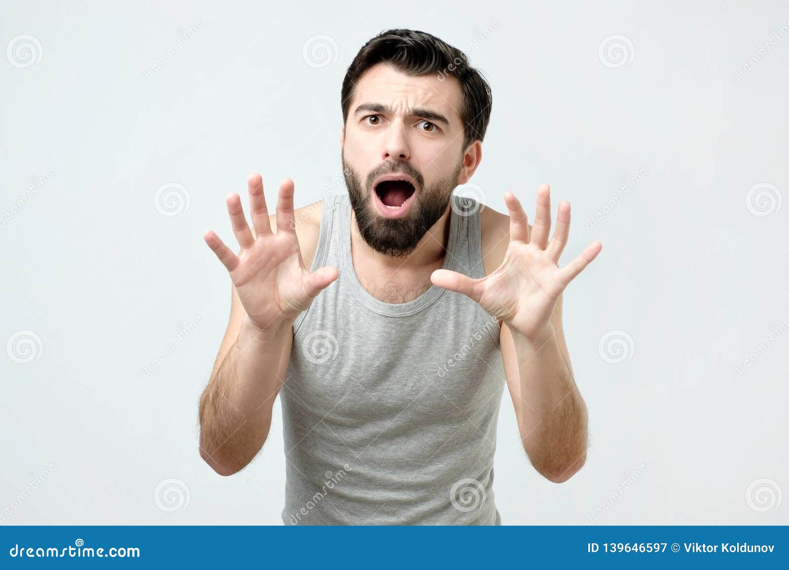 Young Man is Afraid and Terrified with Fear Expression Stop Gesture ... Young Man is Afraid and Terrified with Fear Expression Stop Gesture ...