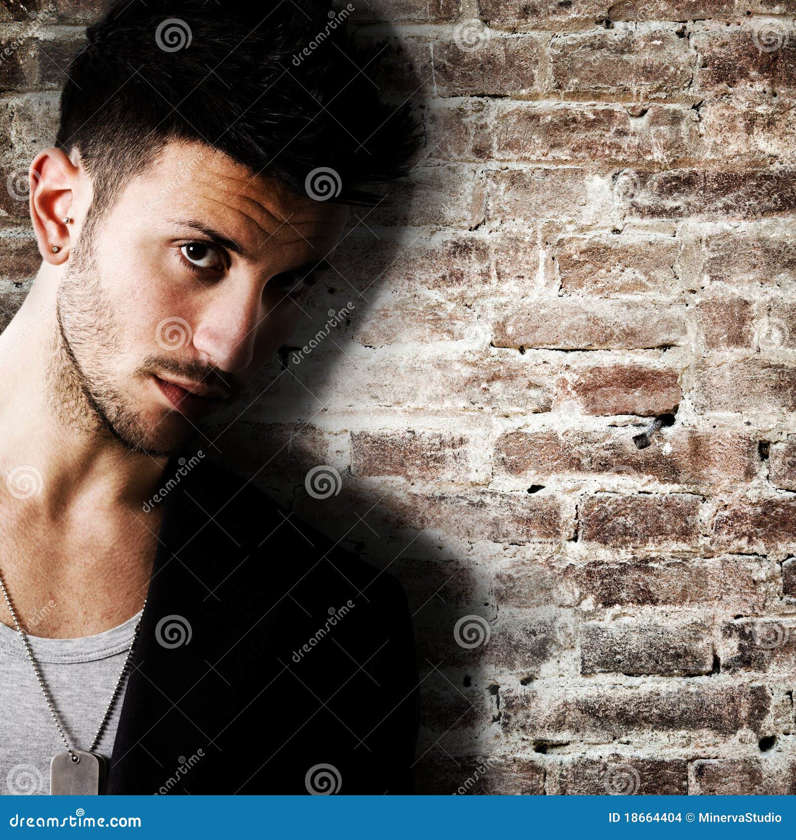 Young Man Against Brick Wall Stock Photo - Image of trendy, night: 18664404