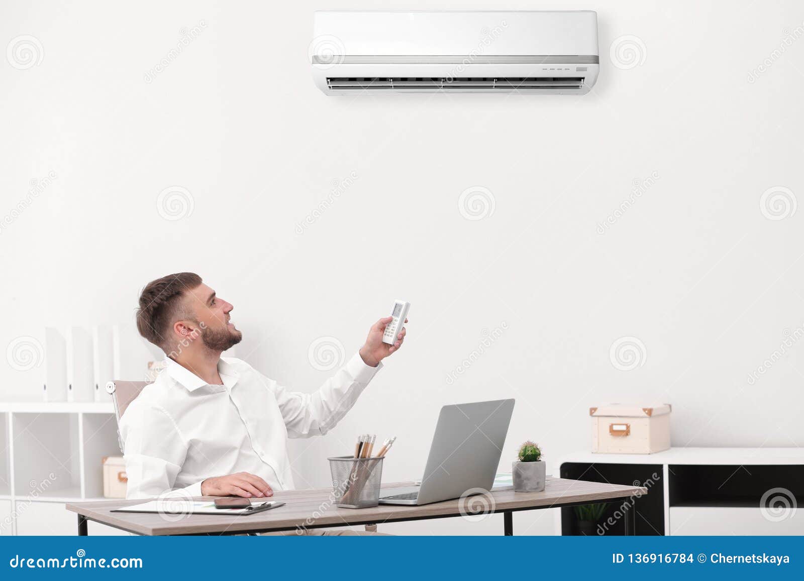 Young Man with Air Conditioner Remote Stock Photo - Image of background ...