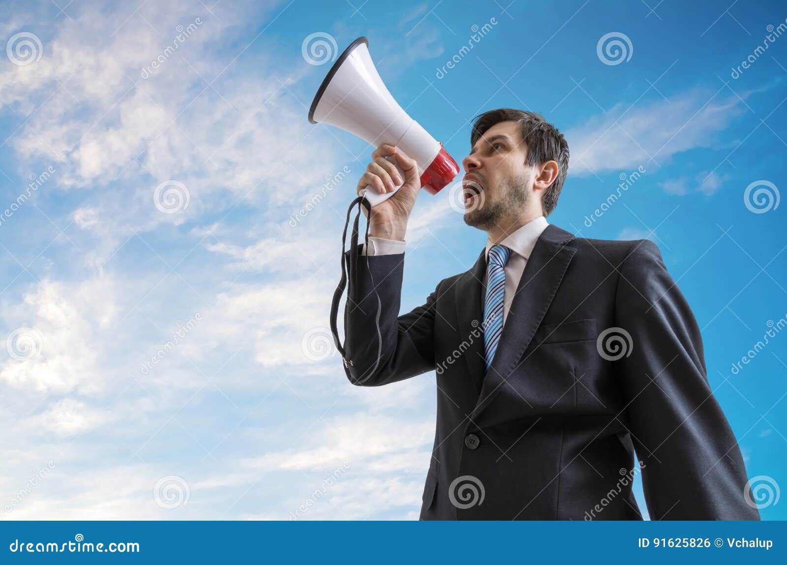 Young Man is Announcing a Message and Speaking To Megaphone. Sky in ...