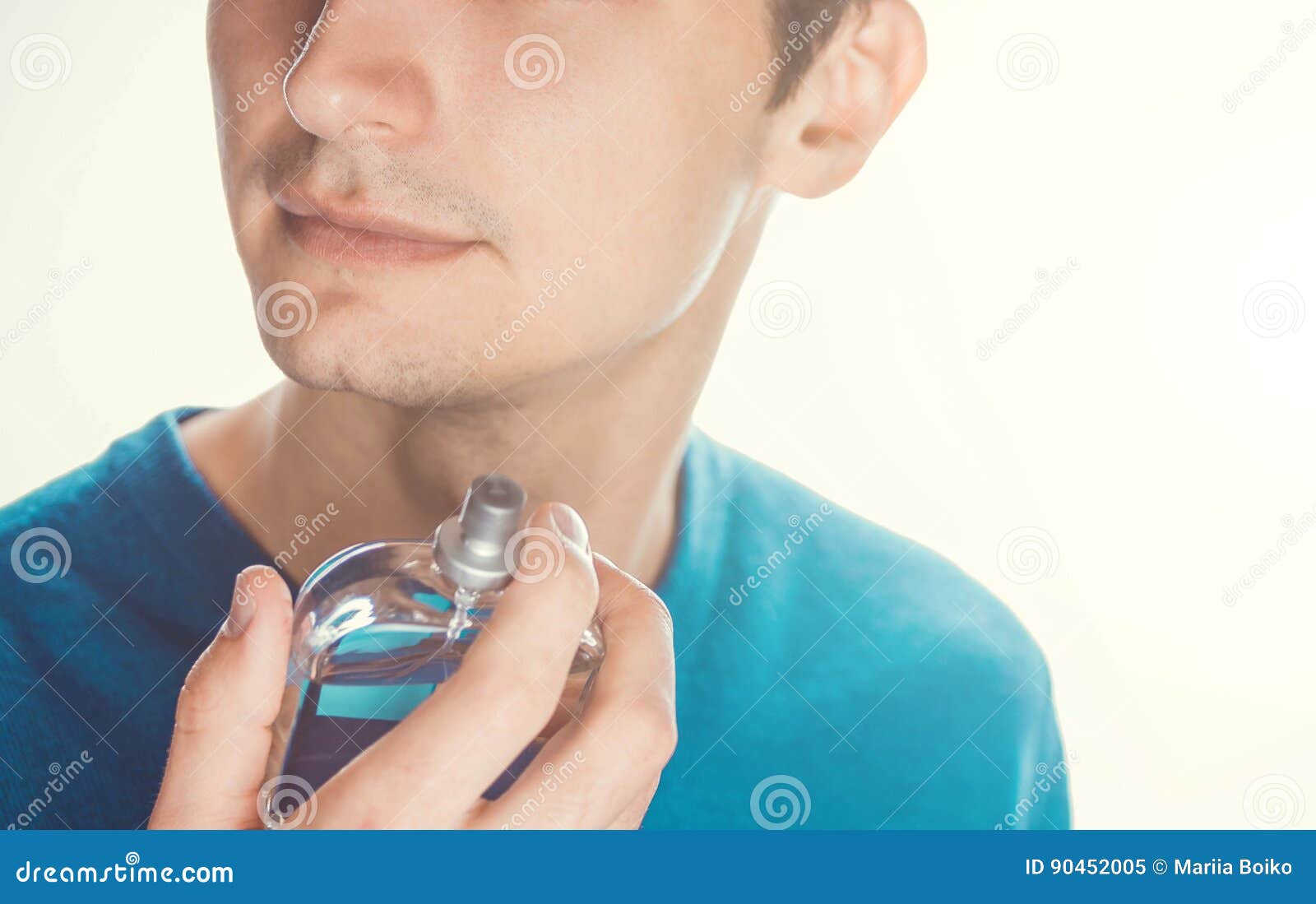 Young man applying perfume stock image. Image of beautiful - 90452005