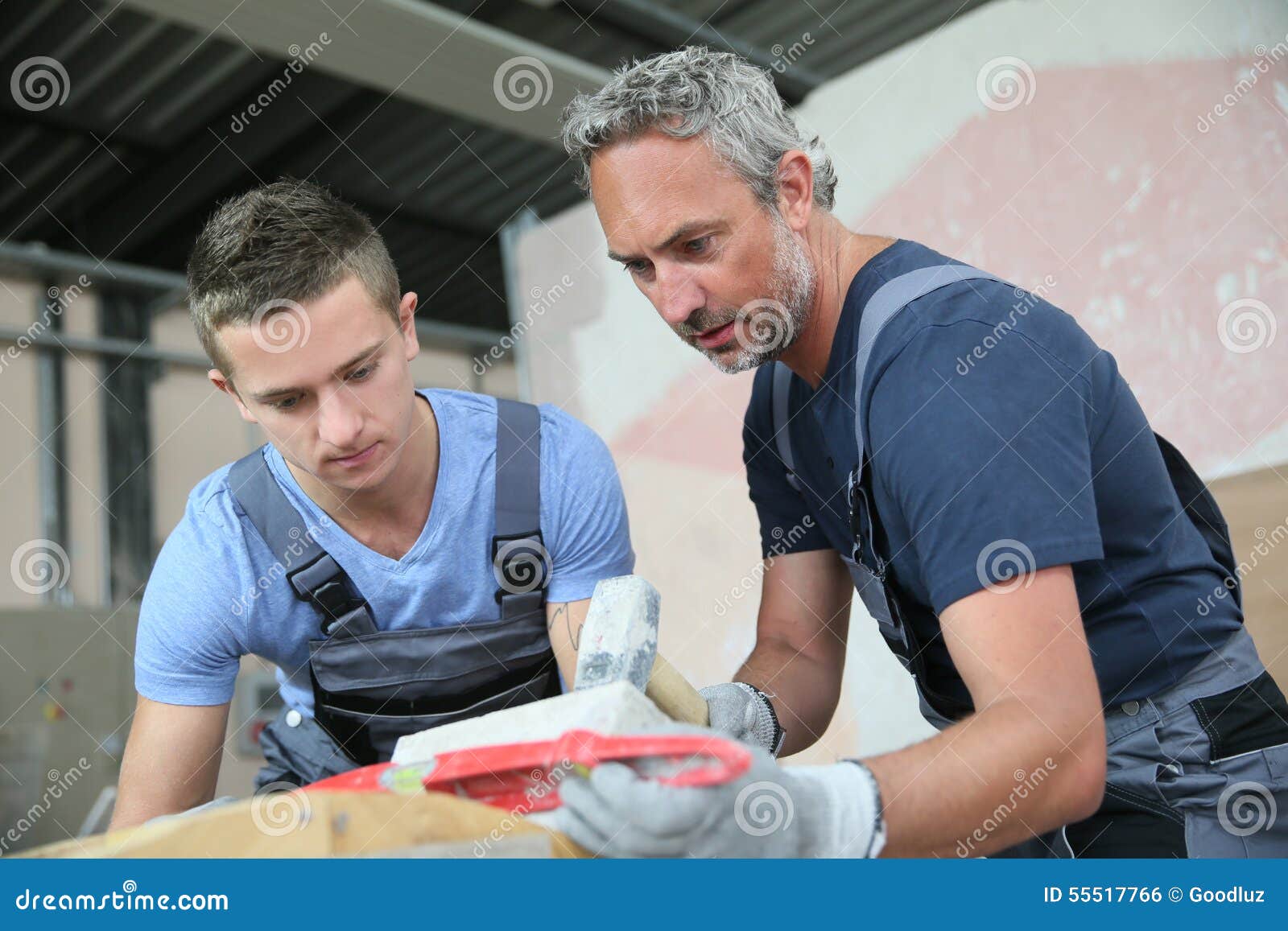 Young Man Apprentice with Instructor in Masonry Stock Photo - Image of ...
