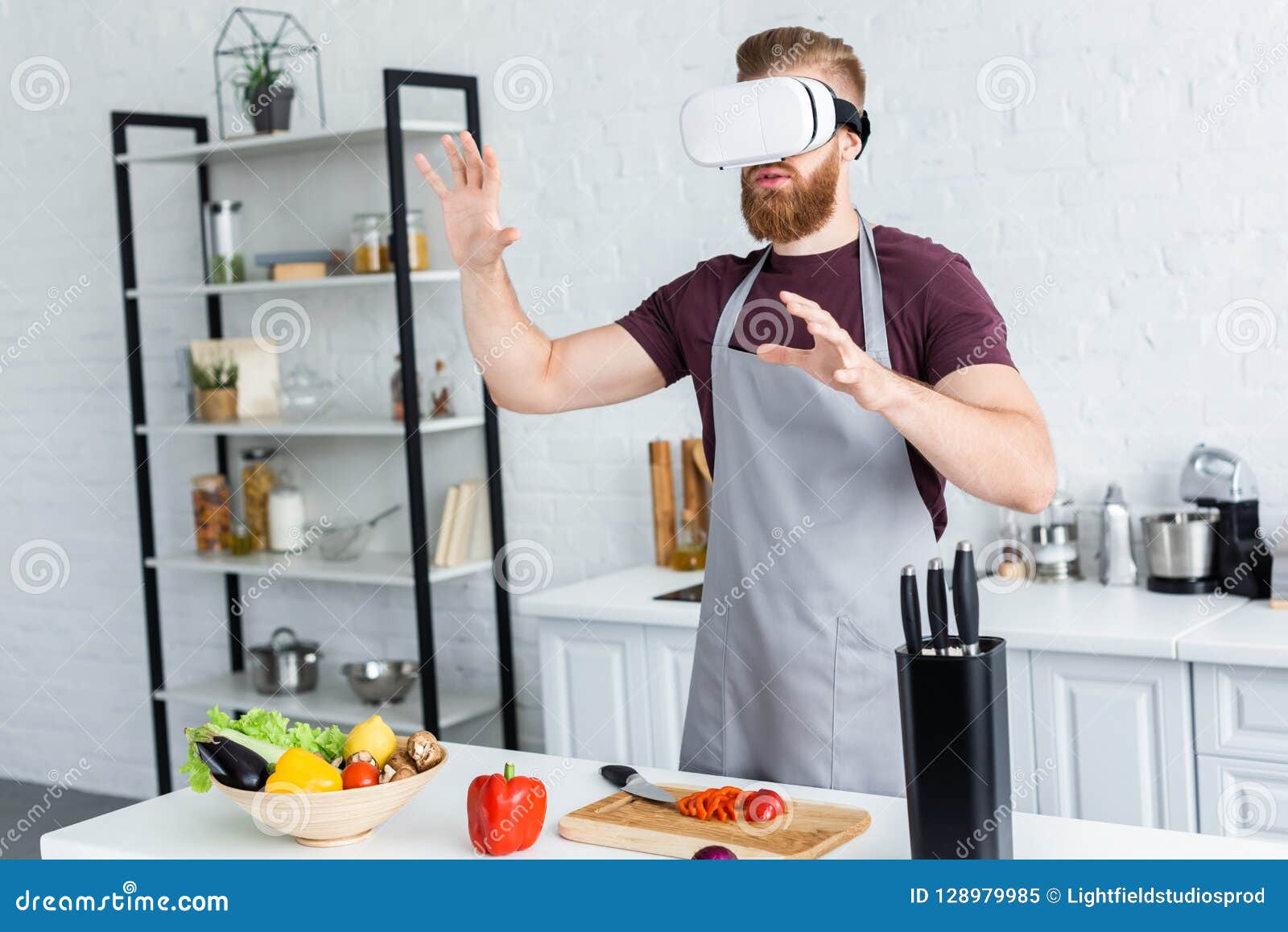 Young Man in Apron Using Virtual Reality Headset while Cooking in ...
