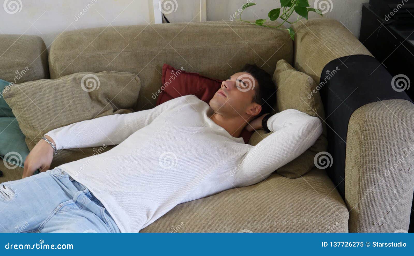 Young Man Arriving at Home and Falling on Couch Stock Video - Video of ...