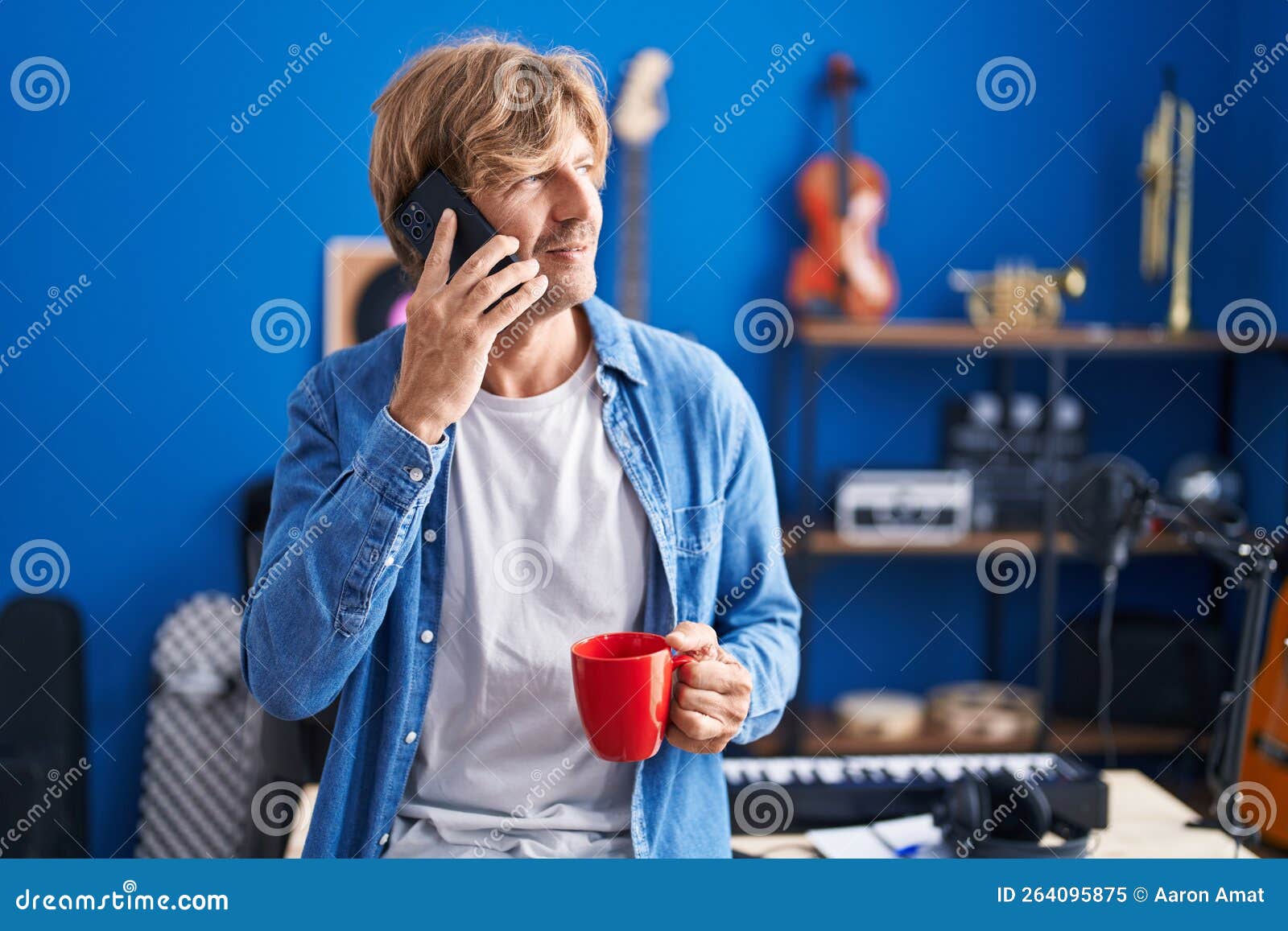 Young Man Artist Talking on Smartphone Drinking Coffee at Music Studio ...